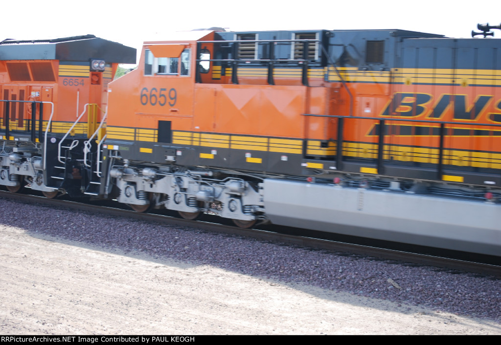 BNSF 6659 with the rear of BNSF 6654 head eastward towards the BNSF Barstow yard.